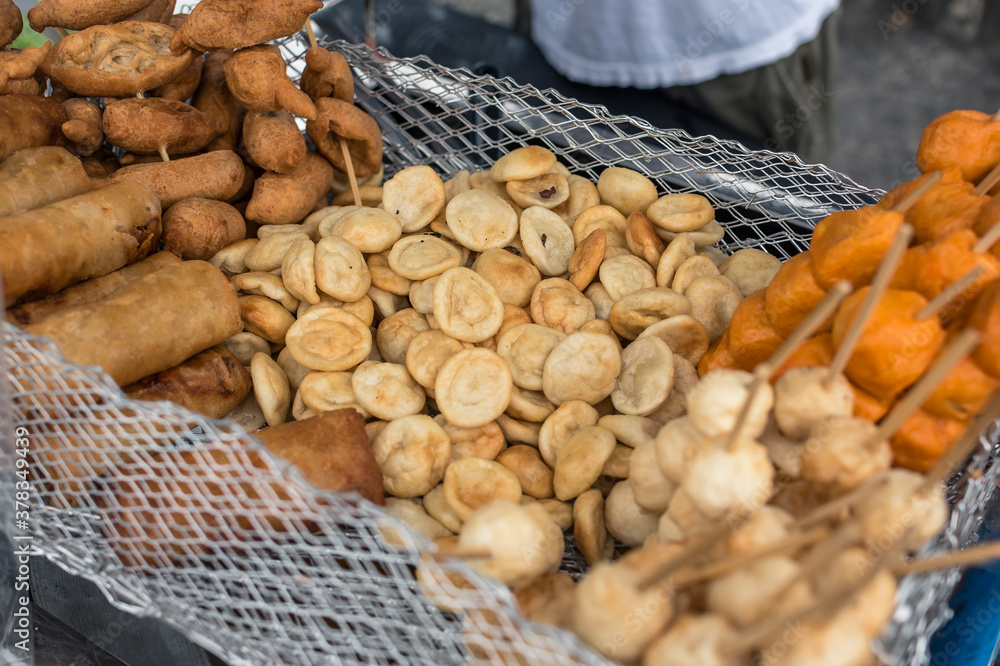 A foodstall in Manila offering freid Lumpia, Kikiam, Fishballs, Kwek ...