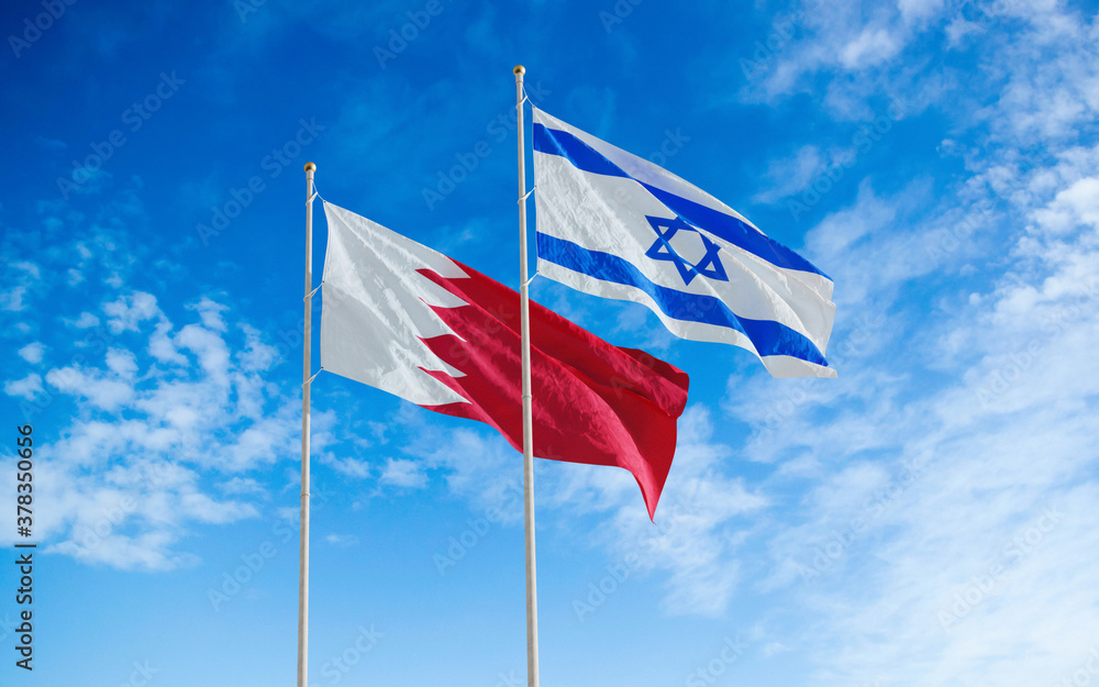 Bahrain and Israel Flags waving against a blue sky background. Bahrain ...