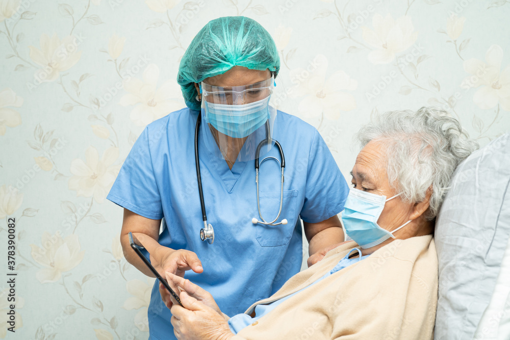 Asian doctor wearing face shield and PPE suit new normal to check ...