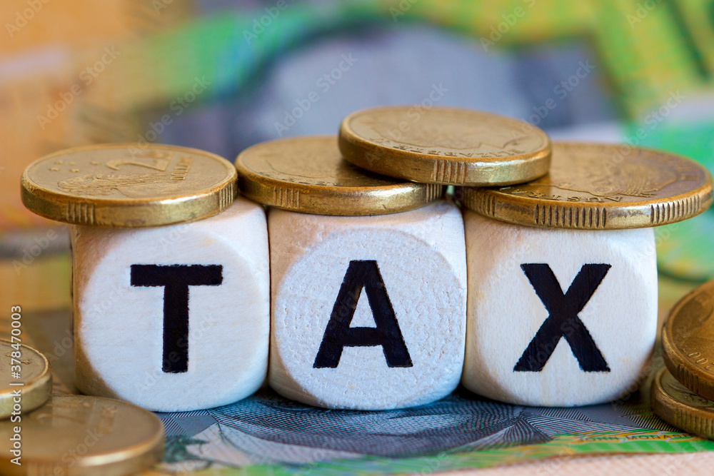 Tax signage with Australian coins and notes. Stock Photo | Adobe Stock