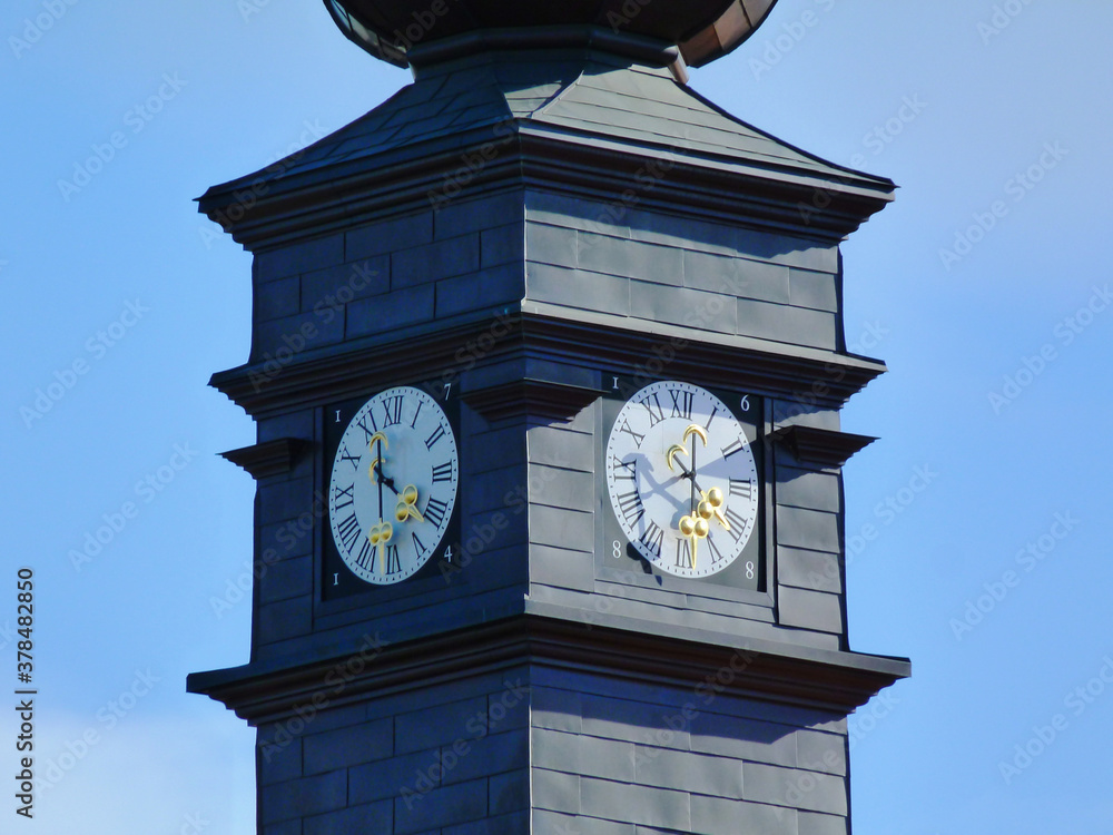 gray zink plated clock tower. horizontal seams and joints. white clock ...