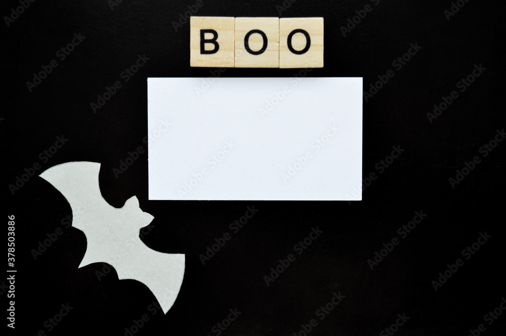 White paper bat lies on a black background with a white mockup. Word ...
