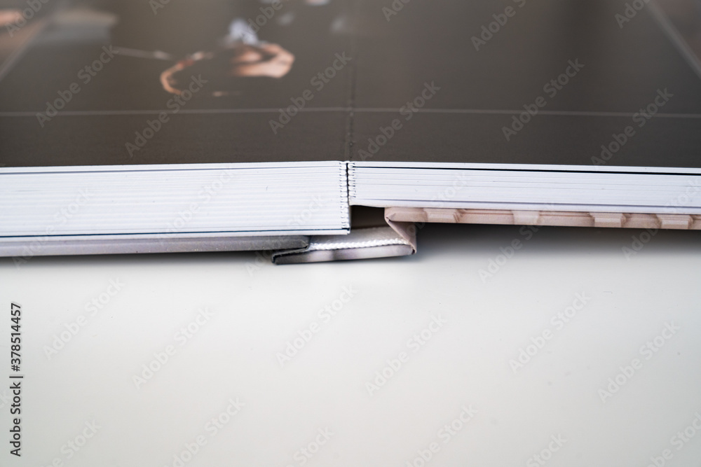 close up. photo book binding. storing photos from a photo session in a ...