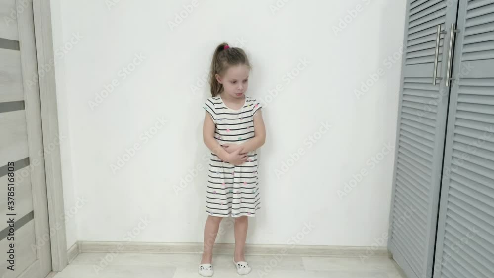 a little girl sitting on the toilet, the problem with the intestines in ...
