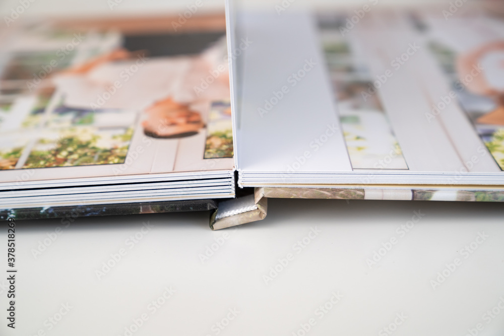 close up. photo book binding. storing photos from a photo session in a ...