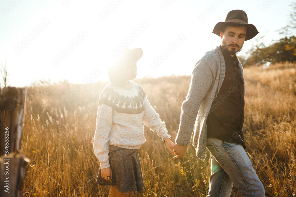 Follow me. Men leads the girl behind him. Stylish and loving hipster ...