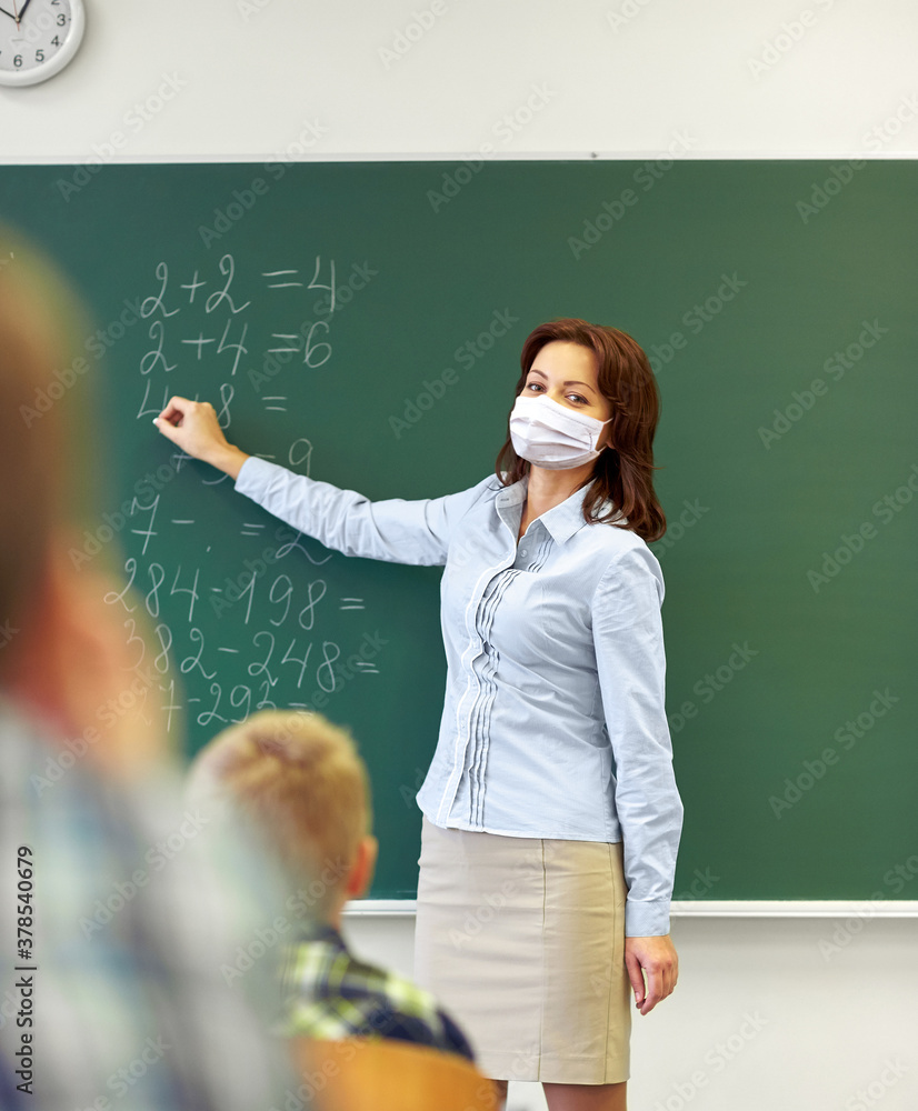 education, school and pandemic concept - female math teacher wearing ...