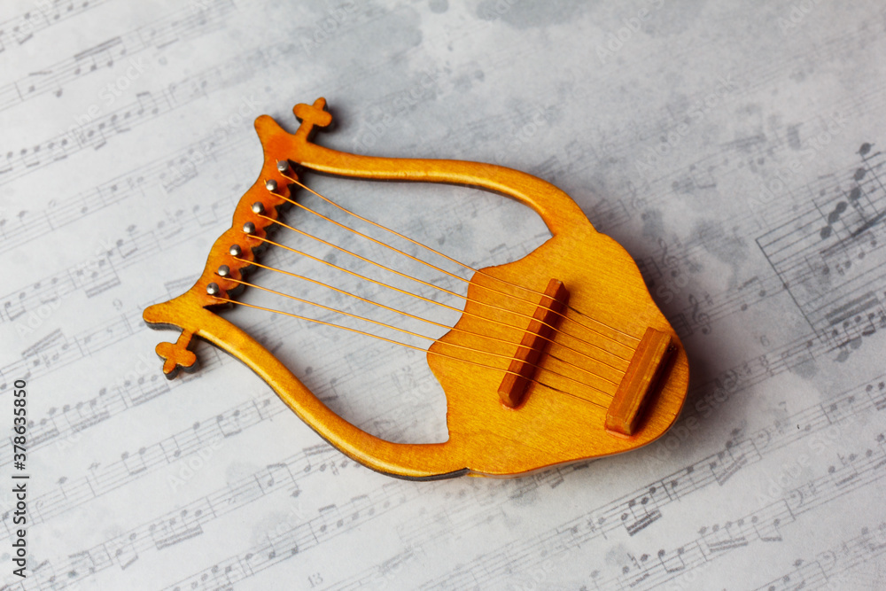 lyre - stringed plucked musical instrument on a musical background. A ...