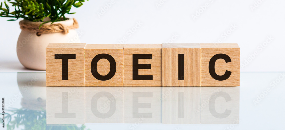 Toeic - acronym from wooden blocks with letters, abbreviation TOEIC ...