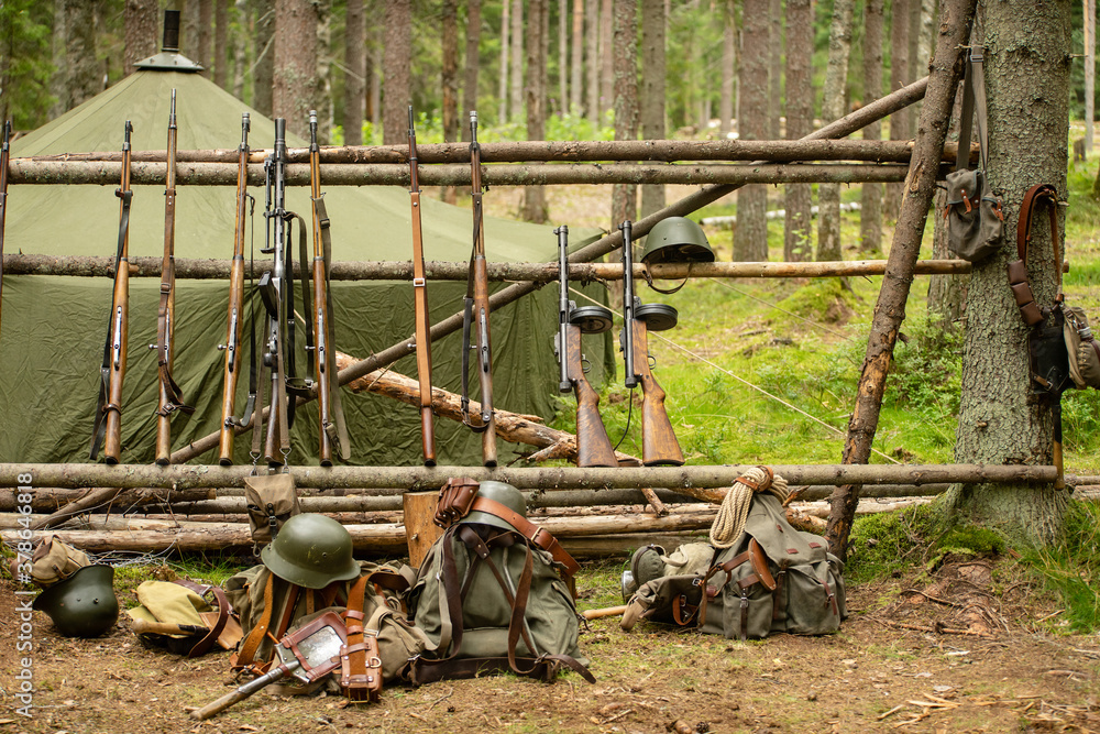 Photo & Art Print Military field camp in the forest, weapons and ...