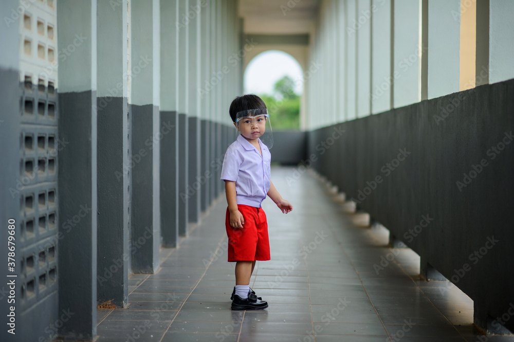 Cute preschooler child wearing face shield at school during covid-19 ...