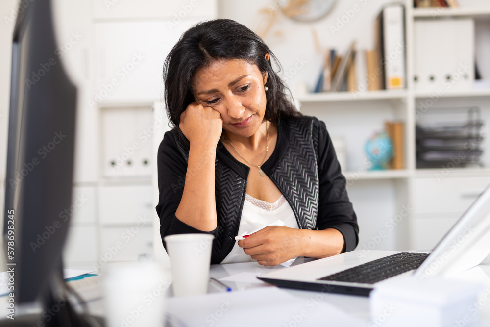 Upset peruvian business woman crying at her workplace in modern office ...