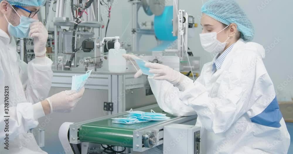 Engineers male and female teamwork in the industrial factory wearing ...