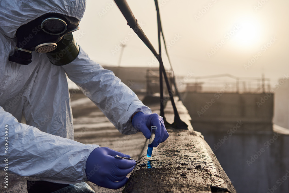 Cropped snapshot of a researcher working on roof of high building ...