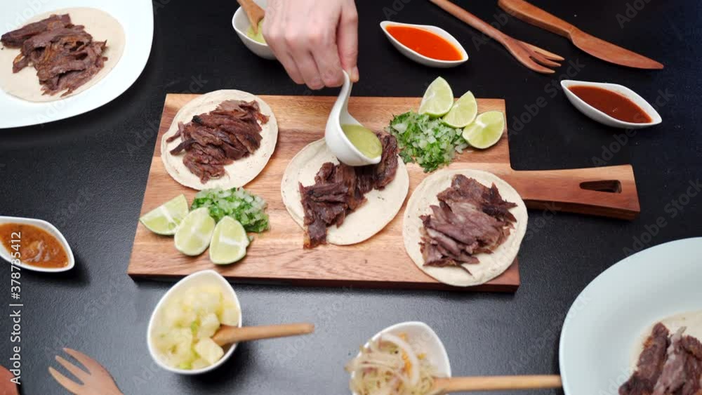 putting salsa to a mexican taco top sirloin beef mexican party top view ...