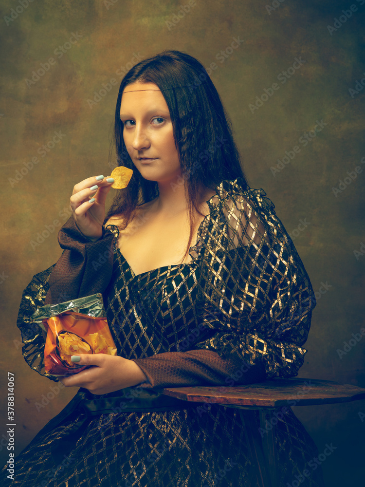 Eating chips. Young woman as Mona Lisa, La Gioconda isolated on dark ...