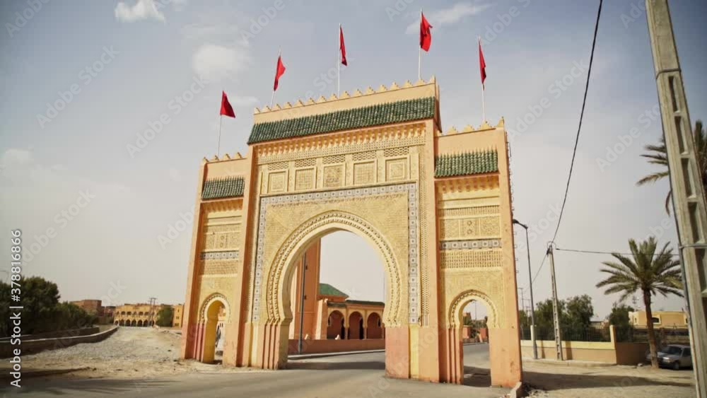 Traditional Moroccan gate with red flags on top, Gate to the Sahara ...