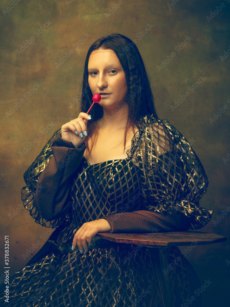 Candy. Young woman as Mona Lisa, La Gioconda isolated on dark green ...
