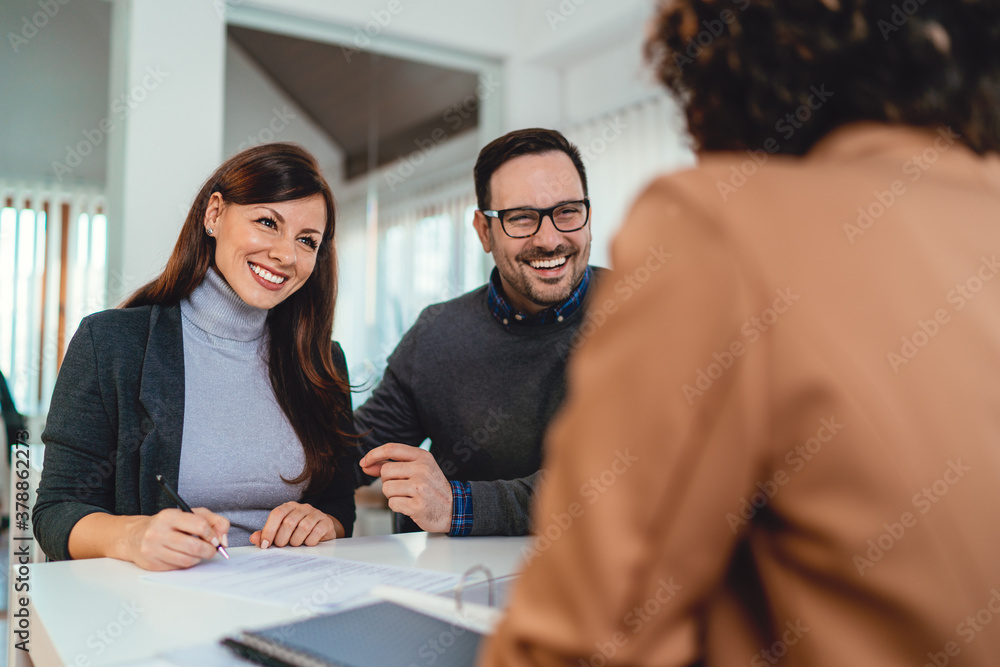 Couple signing loan agreement at the bank Stock Photo | Adobe Stock