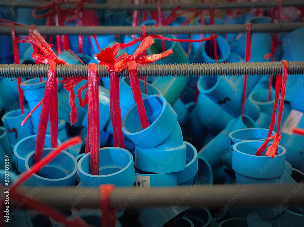 PVC pipe fittings stacked, strapped with plastic inside a storage ...
