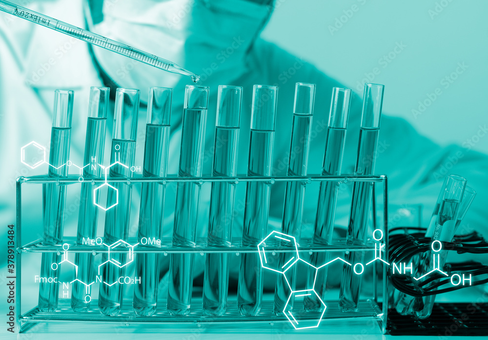 Scientist hand holding pipette dropping a sample into a test tube and ...