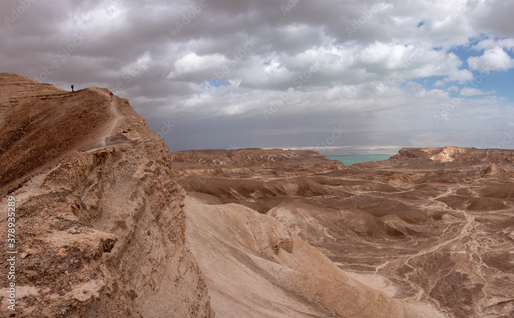 Hikers on a hiking trail in the remote part of the Judean Desert ...