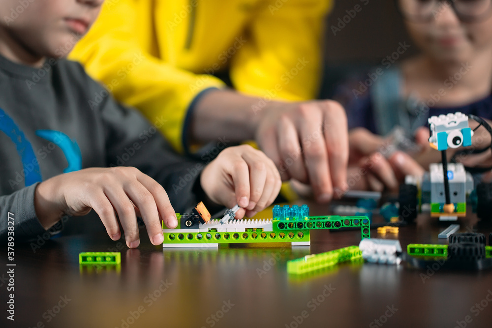 Kids creating robots with teacher. Early development, diy, innovation ...