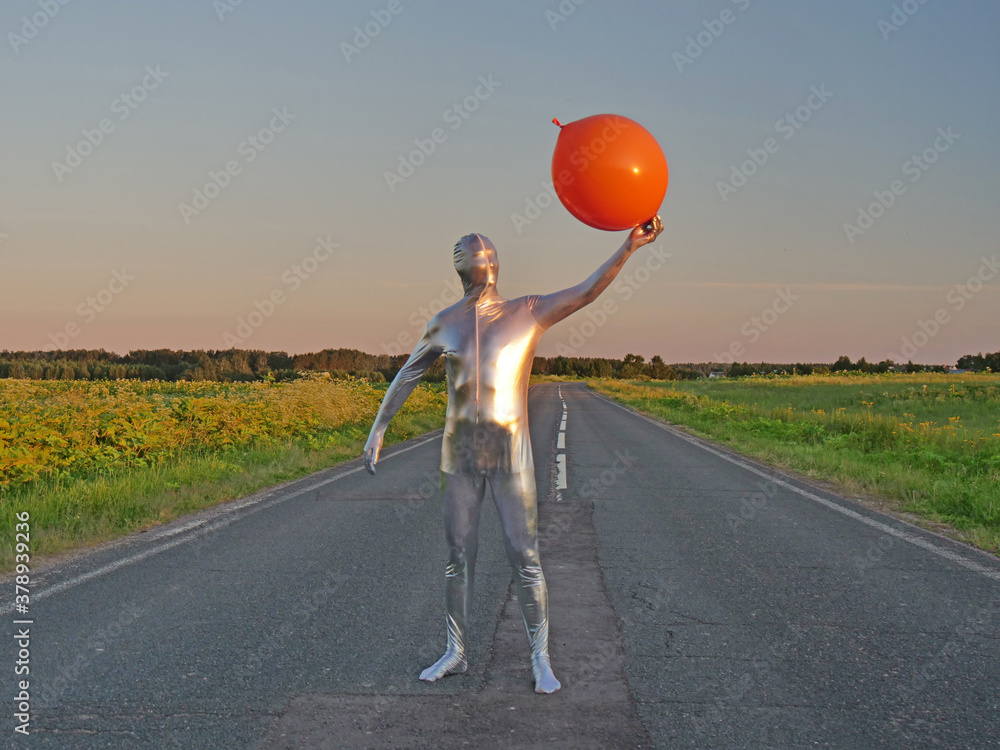 Tall slender man in silver suit is fully dressed in tight silver suit ...