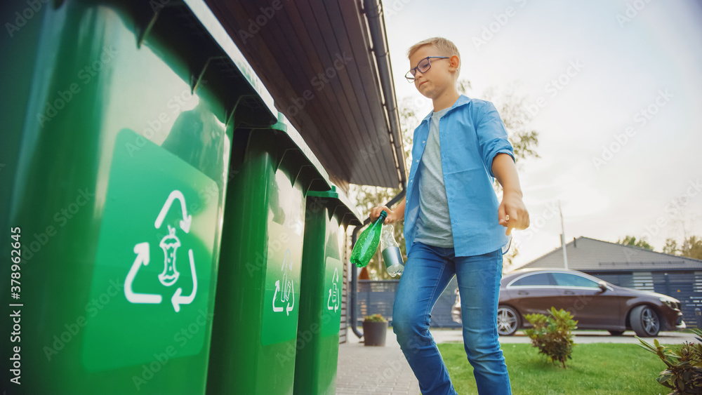 Young Boy is Walking Outside His Home in Order to Throw Away Two Empty ...