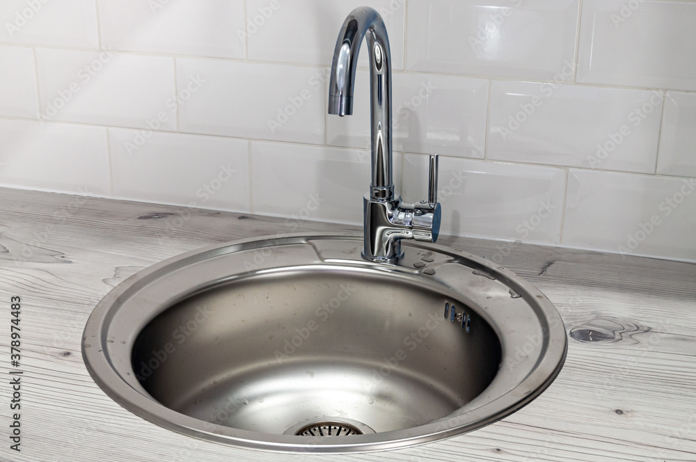 round sink with elegant faucet in a modern kitchen Stock Photo | Adobe ...
