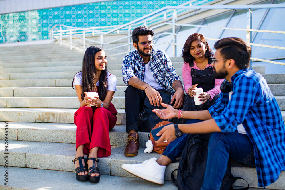 indian friends sitting on stairs outdoors with copybooks Stock Photo ...