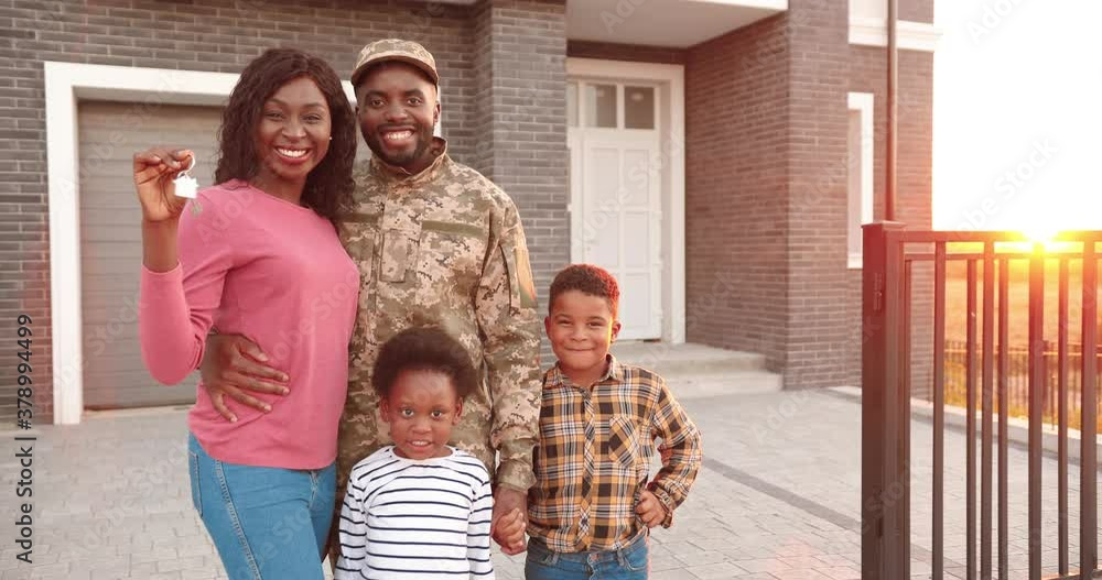 Portrait of African American family of army officer with little kids ...