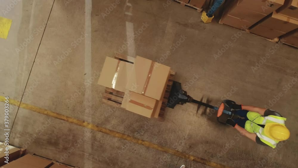 Top-Down Elevating View: Worker Moves Cardboard Boxes using Hand Pallet ...