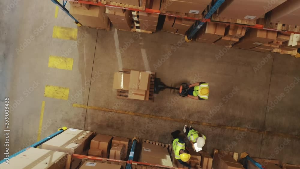 Top-Down Elevating View: Worker Moves Cardboard Boxes using Hand Pallet ...