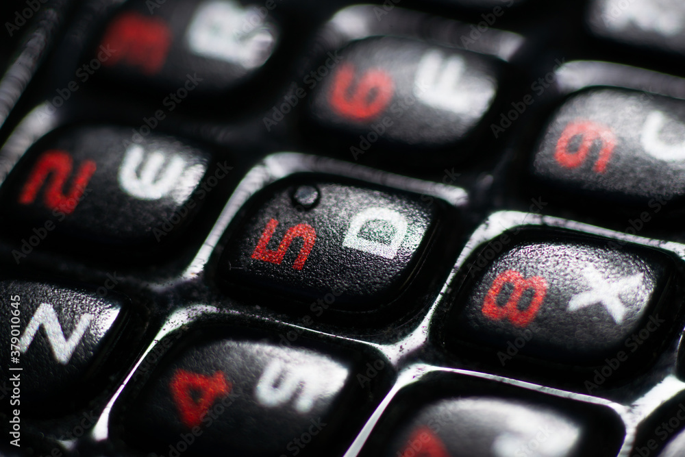 Foto de Physical keyboard of an old telephone. Black keys, red numbers ...