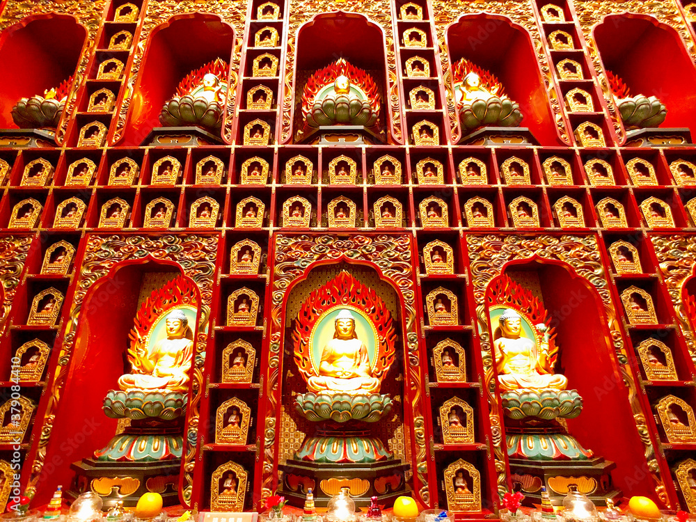 Buddhistic statues inside temple or shrine with buddhas and offerings ...