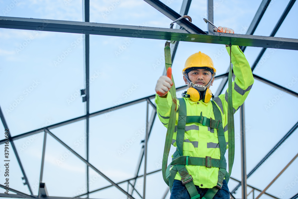 Asian construction worker Wear safety clothing and harnesses to do ...