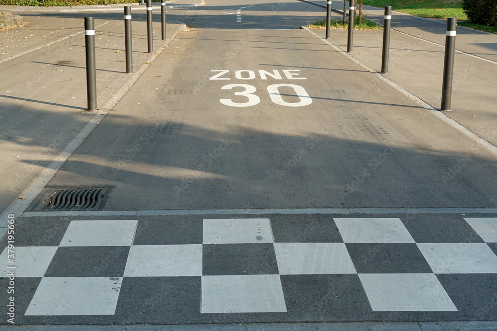 White road marking on the road of 30 km/h zone as a form of speed ...