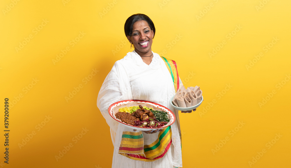 Beautiful Ethiopian chef with a table of Ethiopian food on bright ...
