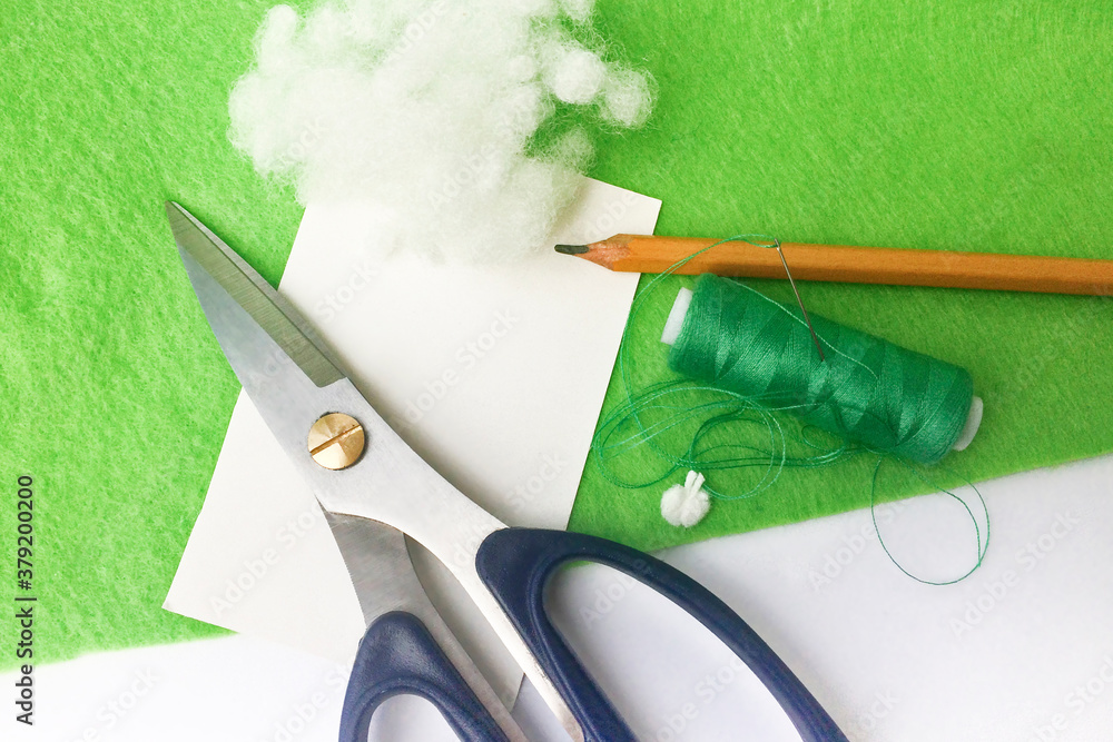 Items for sewing a bunny from felt. Felt, scissors, filler, needle ...