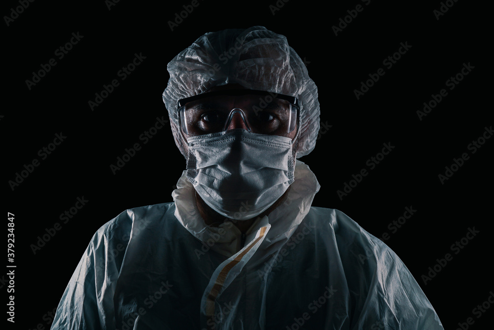 Health worker struggling with the covid-19 virus outbreak. on the dark ...