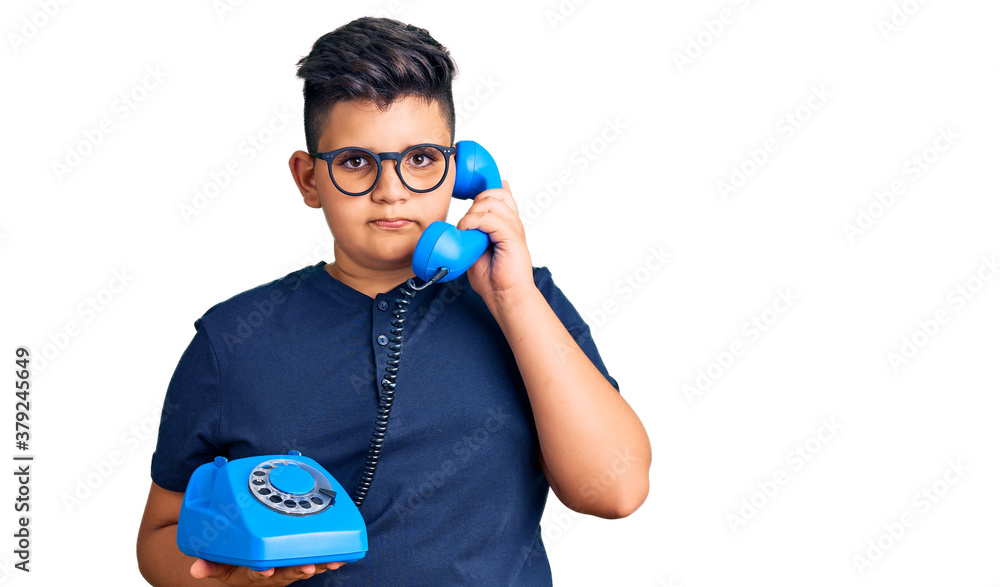Little boy kid using vintage telephone thinking attitude and sober ...