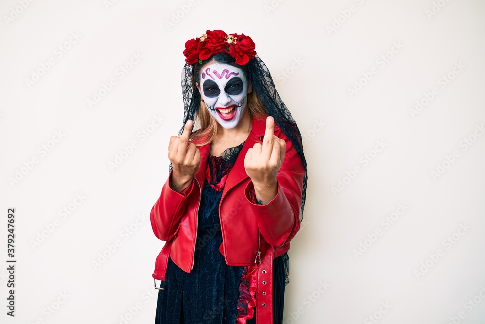 Woman wearing day of the dead costume over white showing middle finger ...