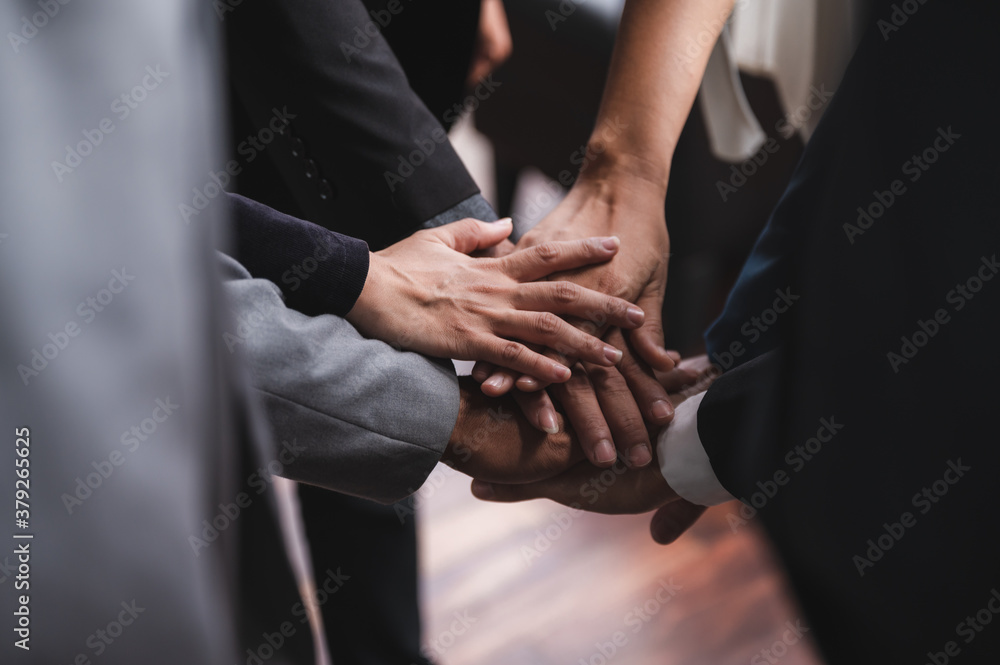 Large business team showing unity with their hands together, business ...