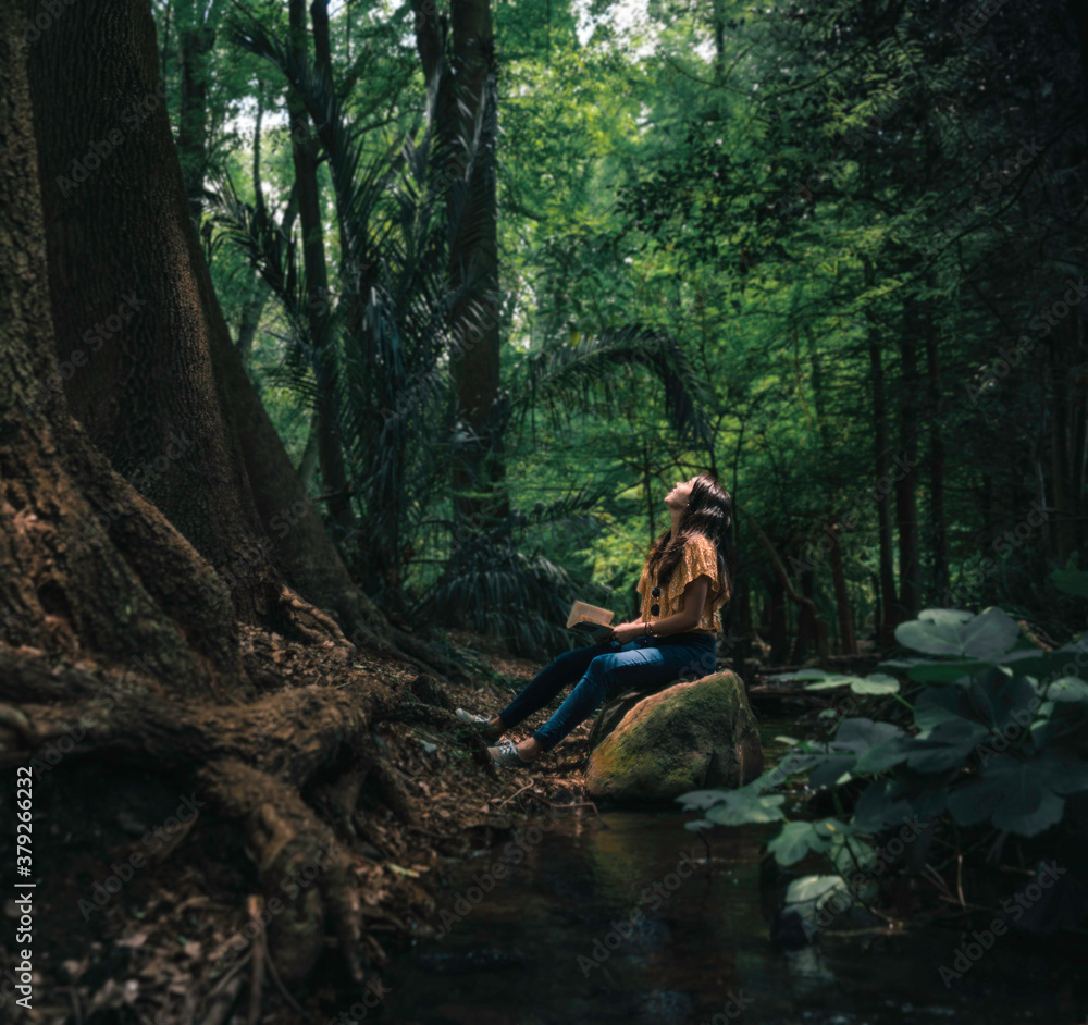 Young girl reading a book and nature background Stock Photo | Adobe Stock