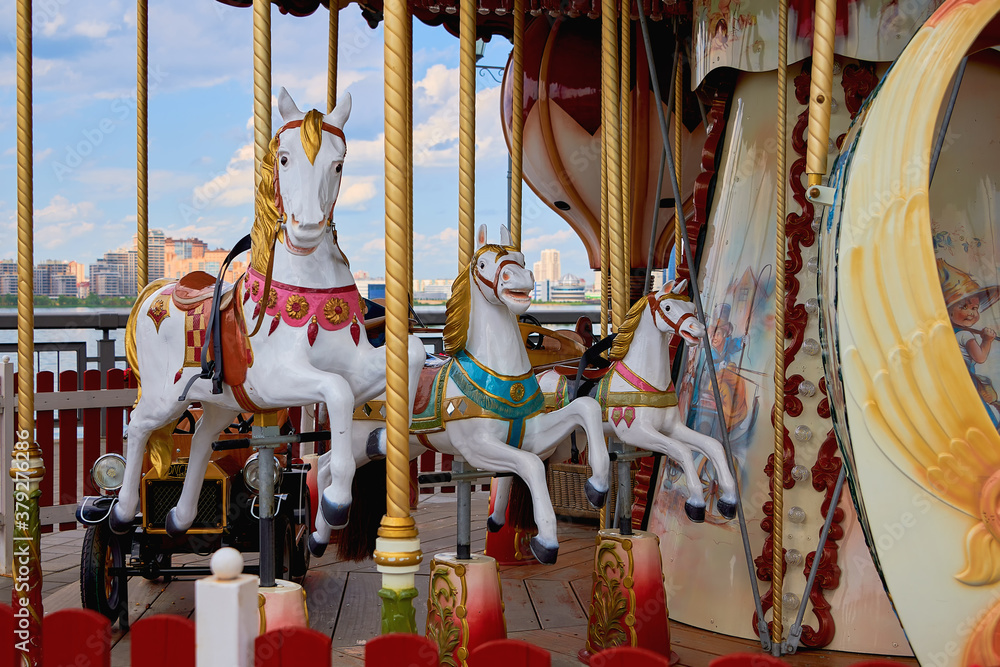 Old carousel in a holiday park. Horses and airplane on a traditional ...