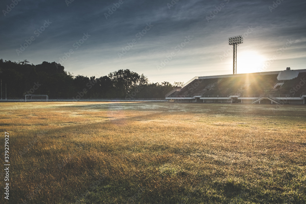 Beautiful sunset over the sport field in stadium. Football arena with ...