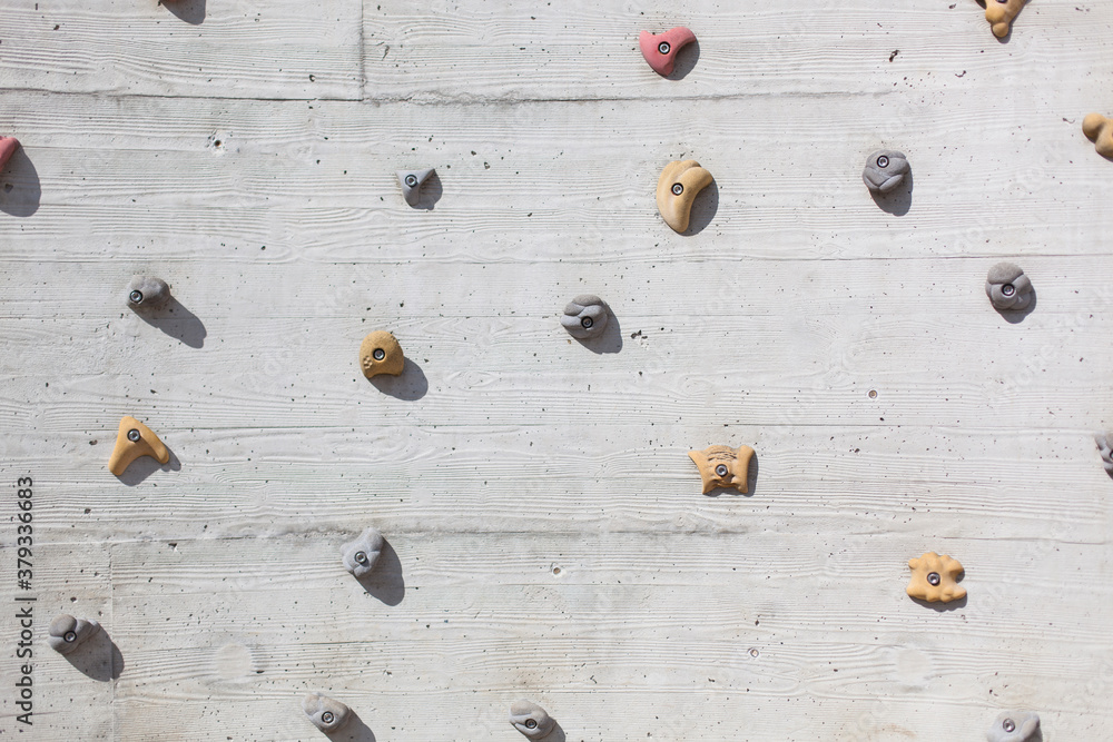 Concrete climbing wall. Climbing holds on wall. Wooden formwork poured ...