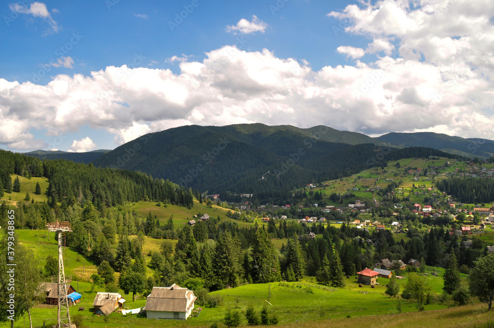 beautiful mountain landscape with bright clouds and sunlight in the sky ...