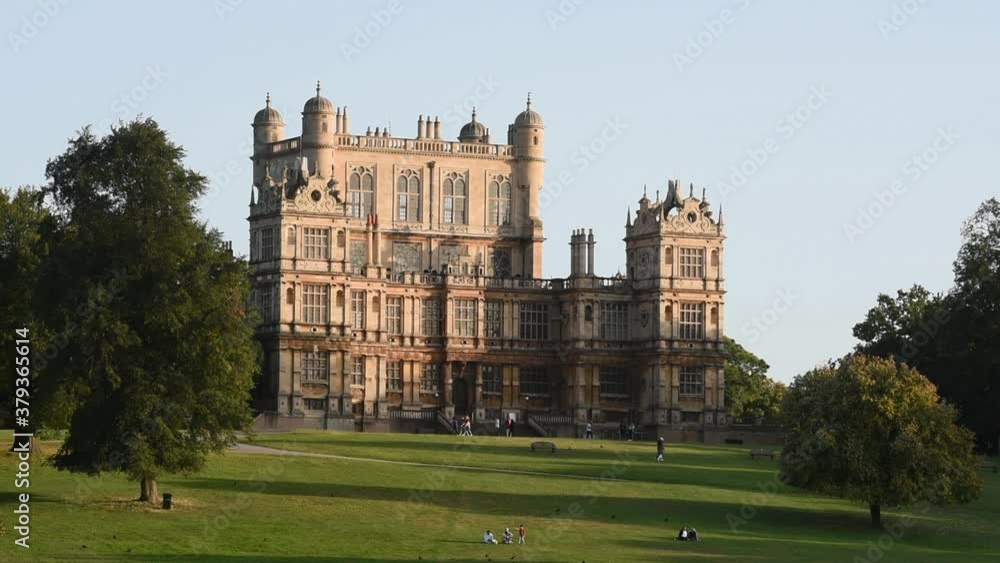 A view of the historic Wollaton Hall at sunset on the grounds of ...